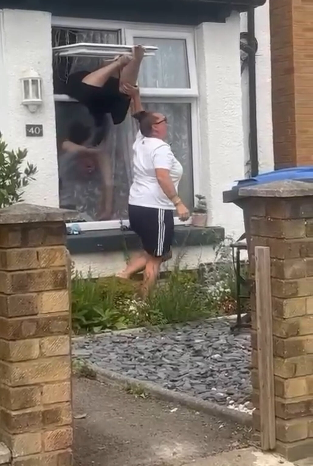 Woman exposes herself falling in window in viral video